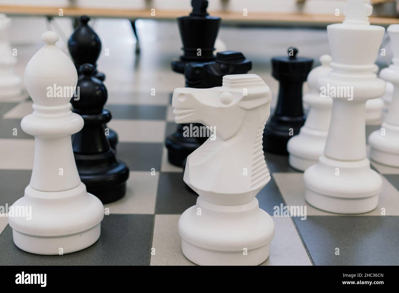 Giant chess on the board located on a ground floor Stock Photo - Alamy