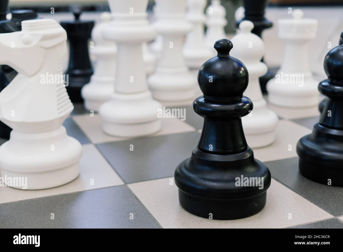 Giant chess on the board located on a ground floor Stock Photo - Alamy