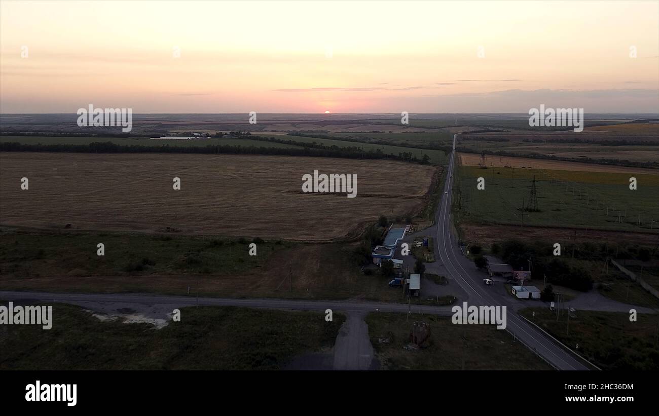 Aerial view of rural road passing through agricultural land and ...