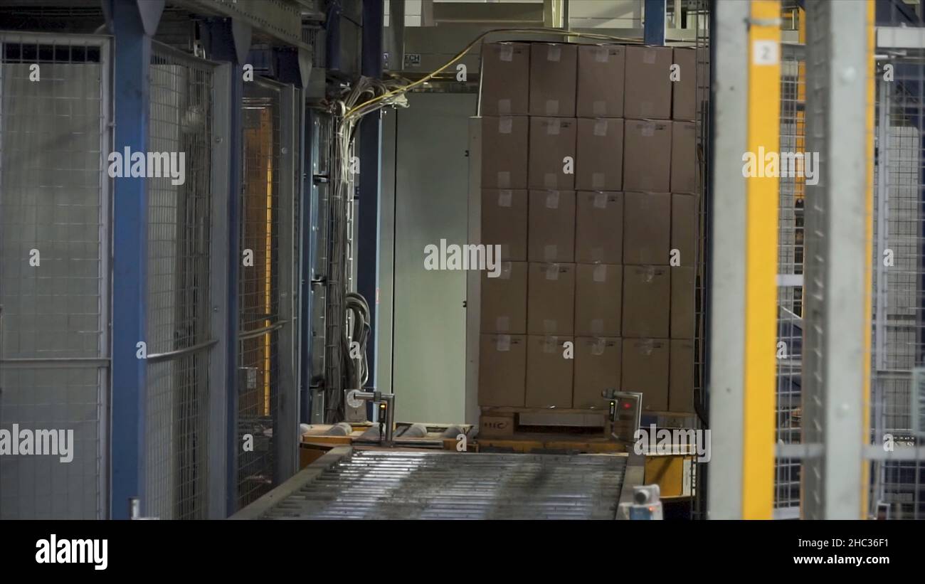 Shipping box in motion on conveyor belt, end of the line. Moving ...