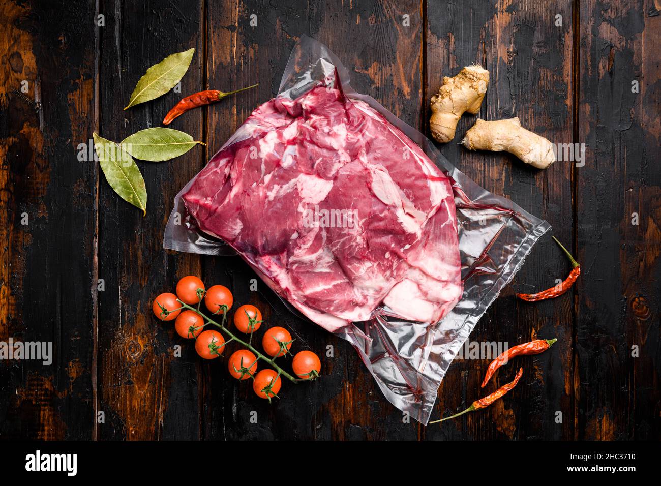 Fresh raw mutton shoulder meat set, with ingredients and herbs, on old ...