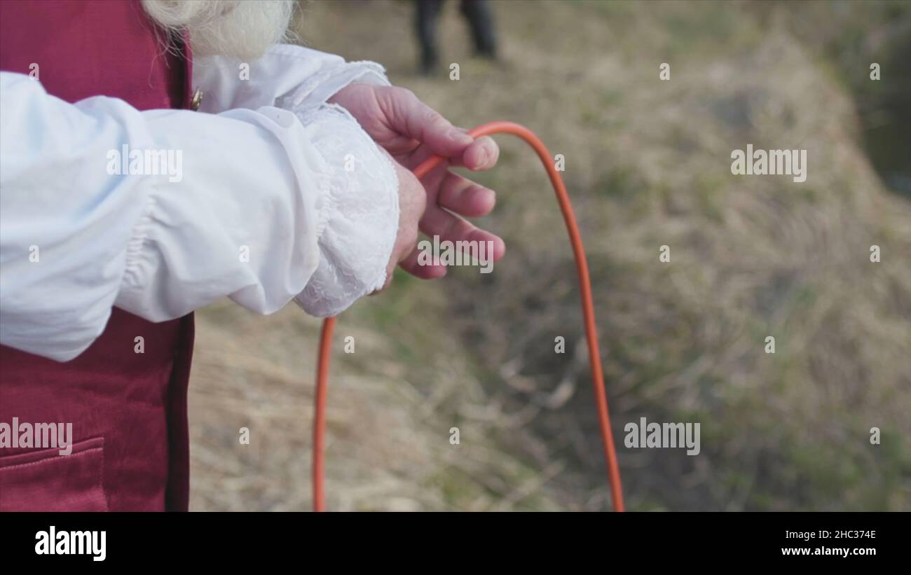Ancient fishing technique, fisherman in old fashioned costume getting a ...