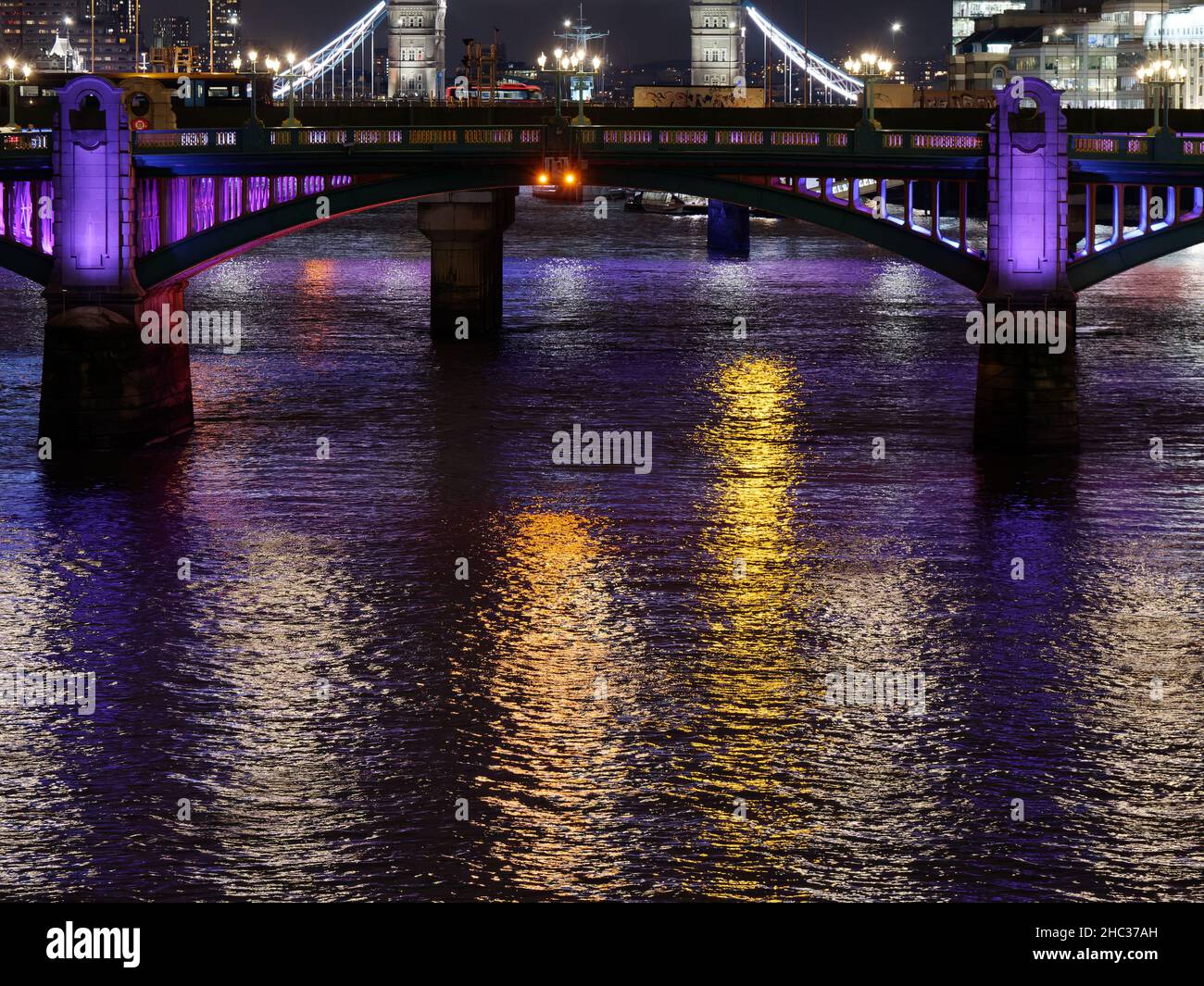 Multi coloured lights reflecting on the River Thames on a winters night ...