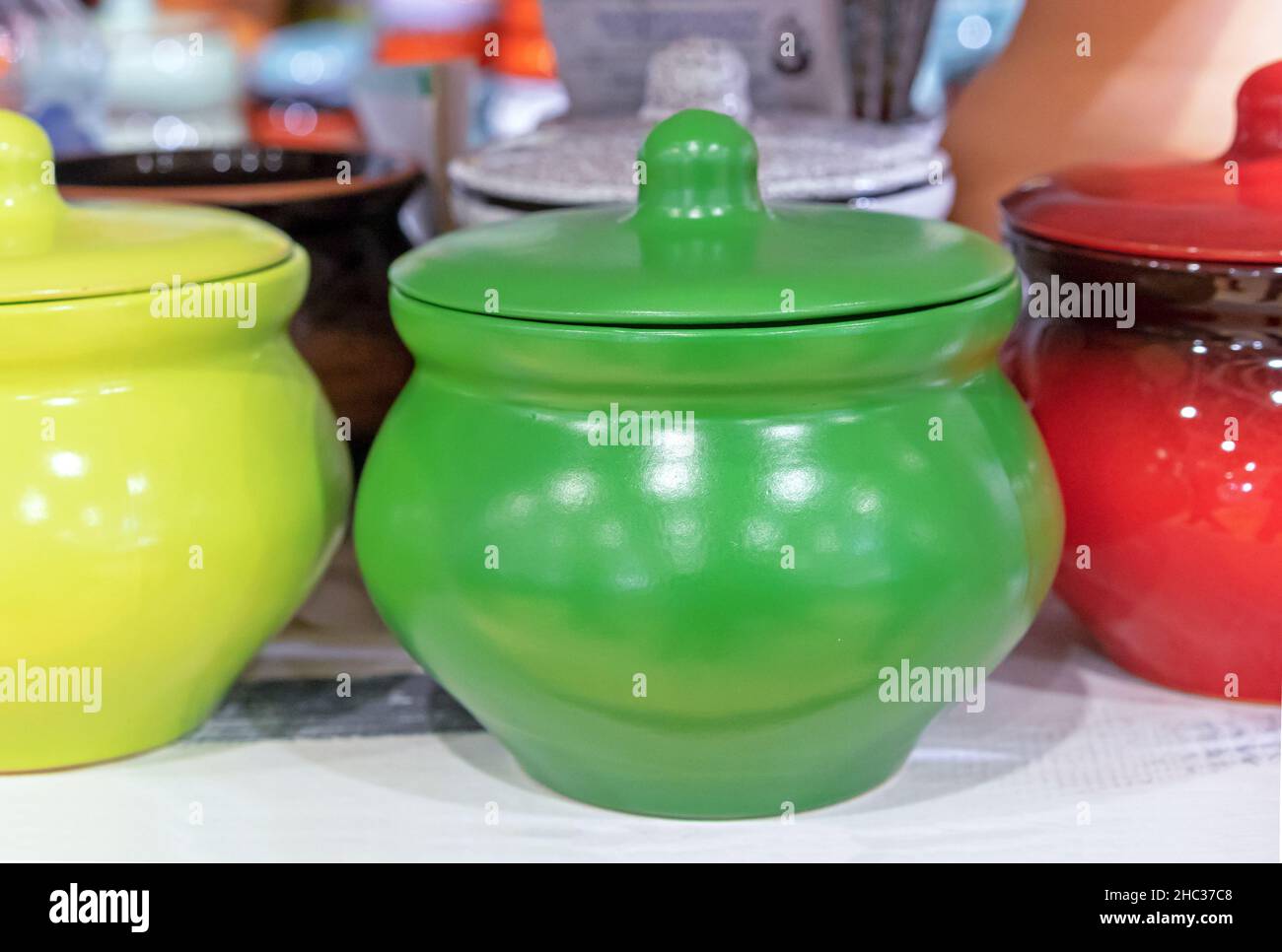Multi-colored ceramic pots with covers for cooking Stock Photo - Alamy