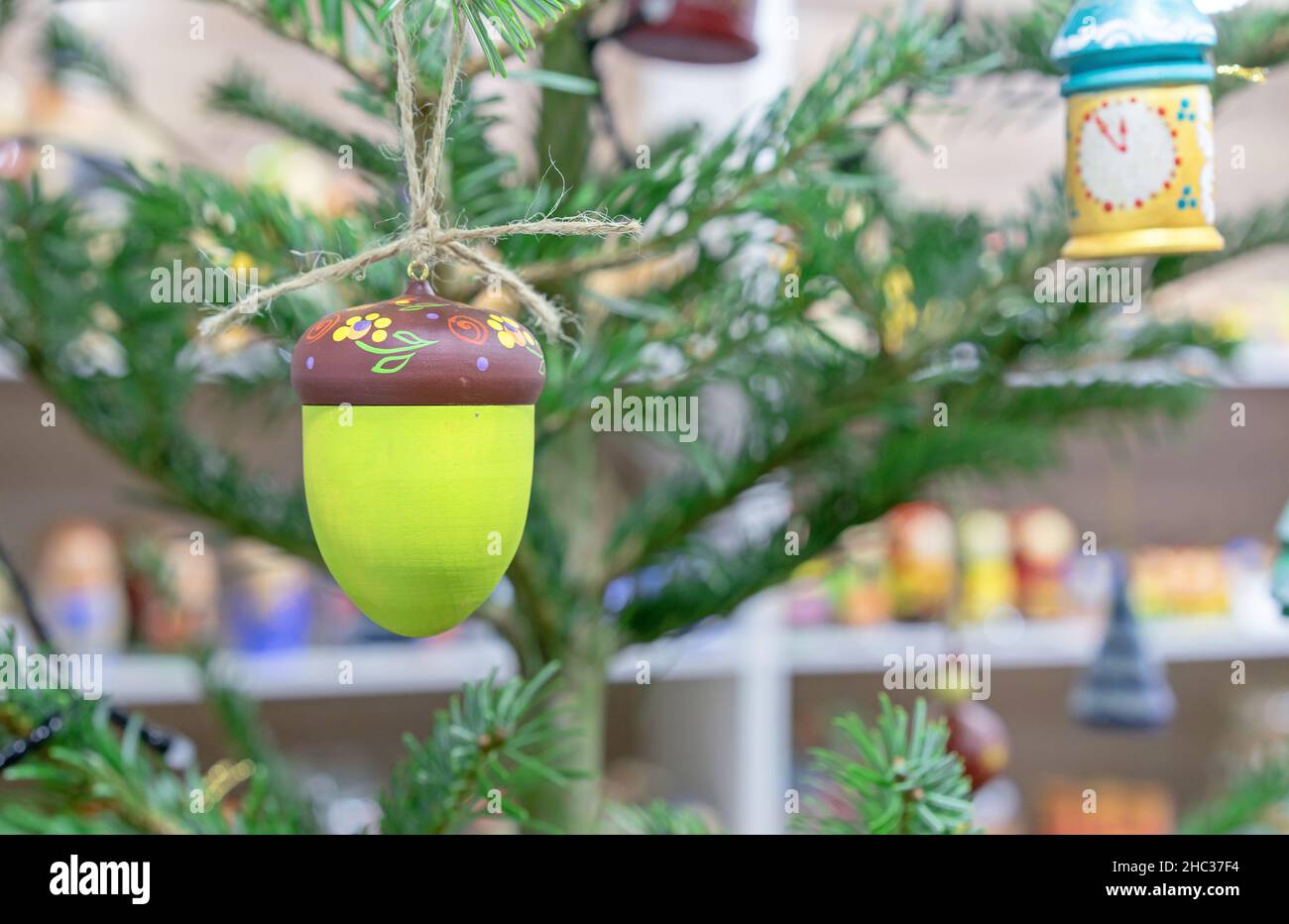 Wooden green oak acorn on a Christmas tree Stock Photo - Alamy