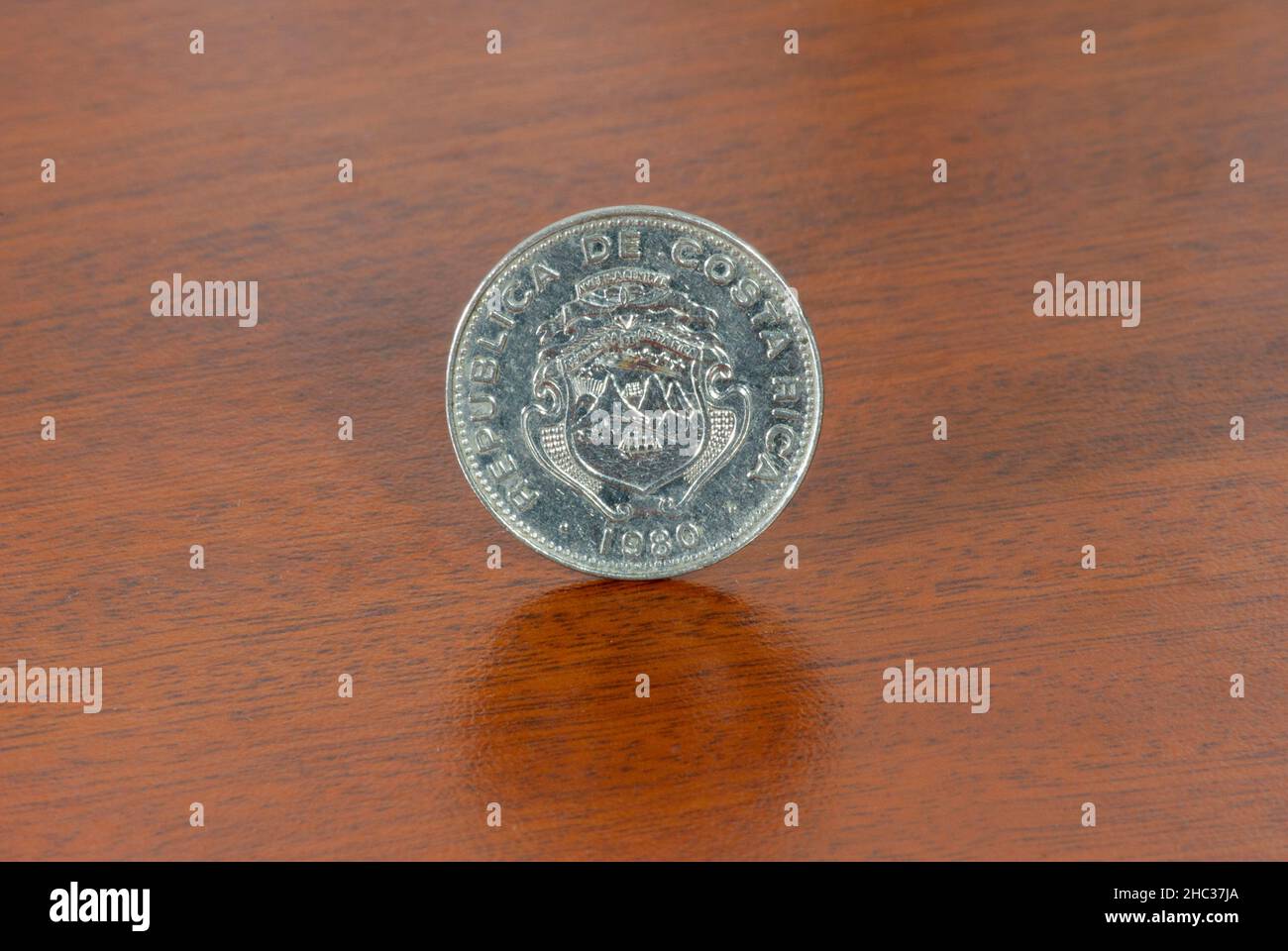 Costa Rica coin 5 Colones 1985, currency over wood texture Stock Photo ...