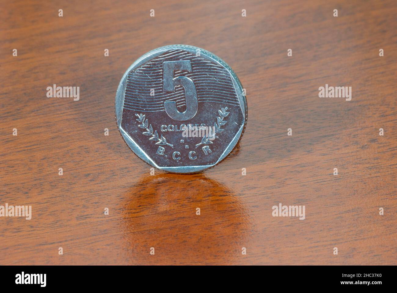 Costa Rica coin 5 Colones 1985, currency over wood texture Stock Photo ...