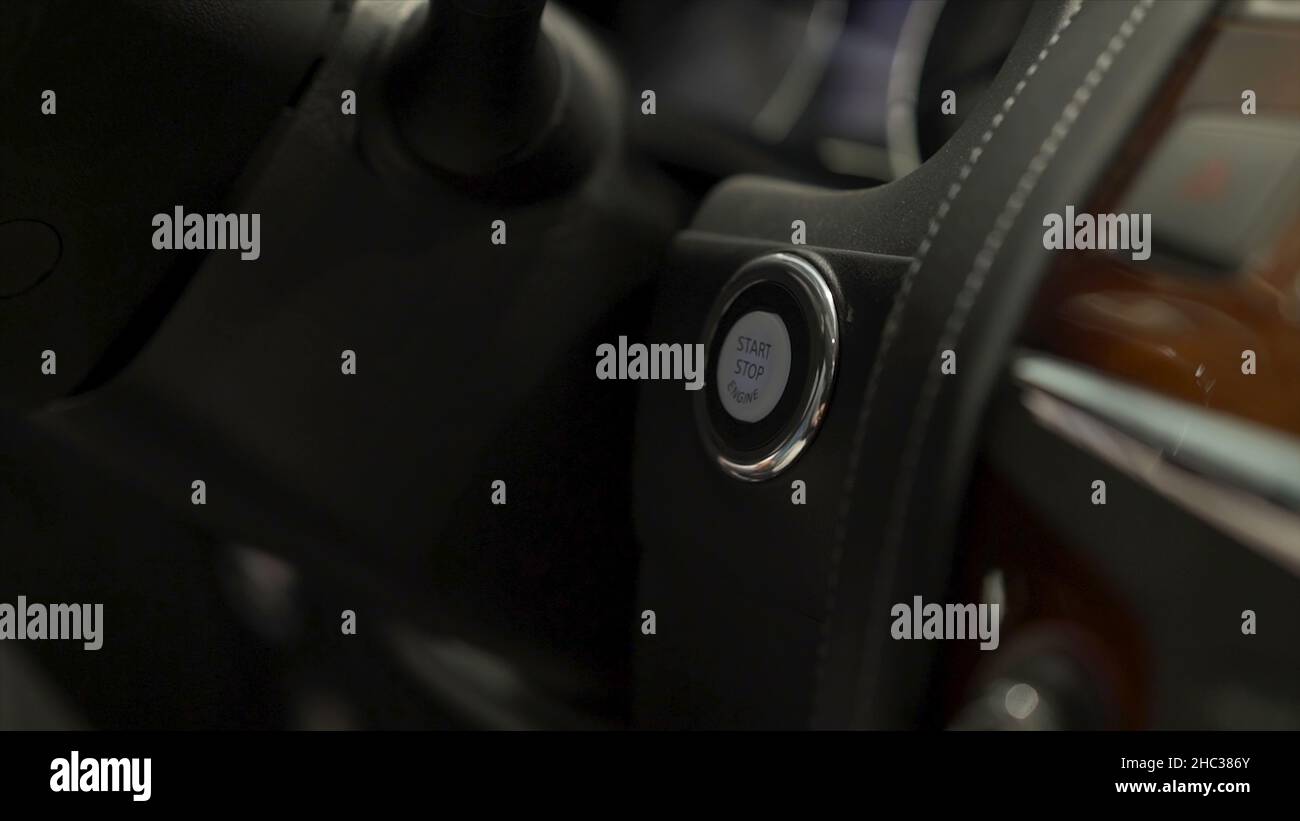Close up for car driver starting the engine of the modern vehicle ...