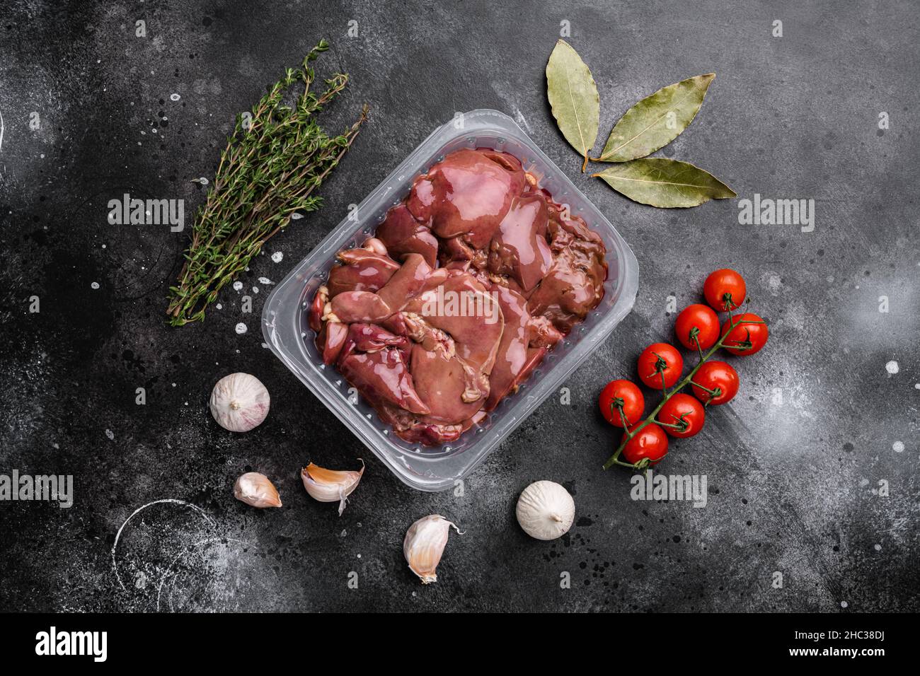 Fresh chicken liver in a disposable one-off packaging set, on black ...