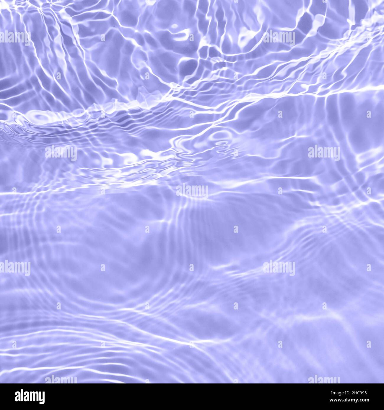 The surface of light on the purple transparent swimming pool water ...