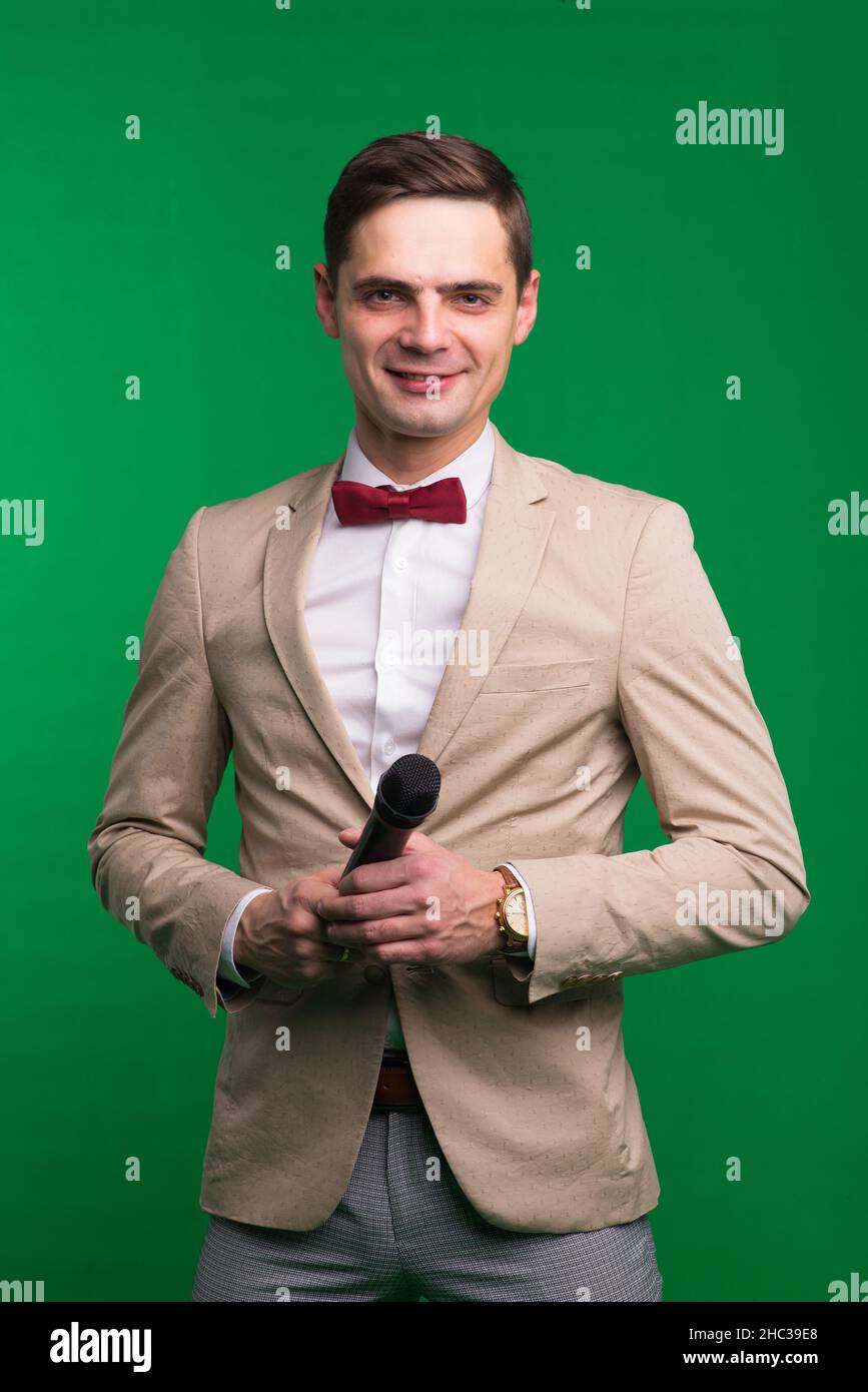 Portrait of professional male reporter holding microphone, isolated on ...