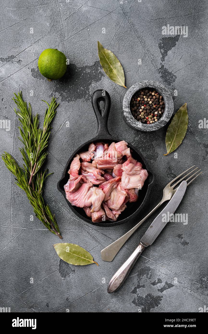 Raw uncooked chicken gizzards, stomach set, on gray stone table ...