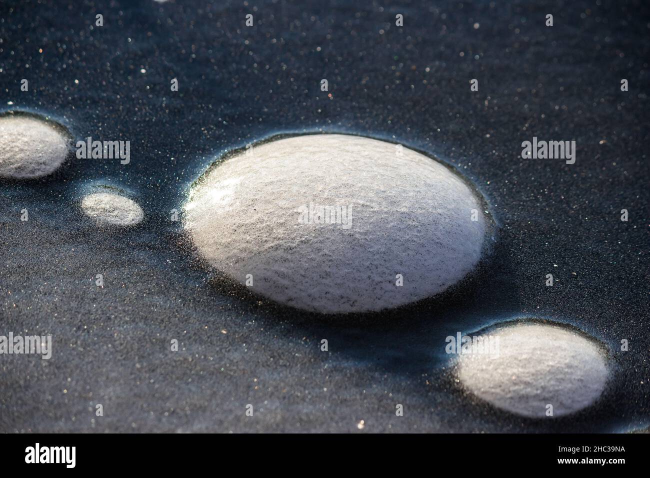 Frozen air bubbles on ice Stock Photo - Alamy