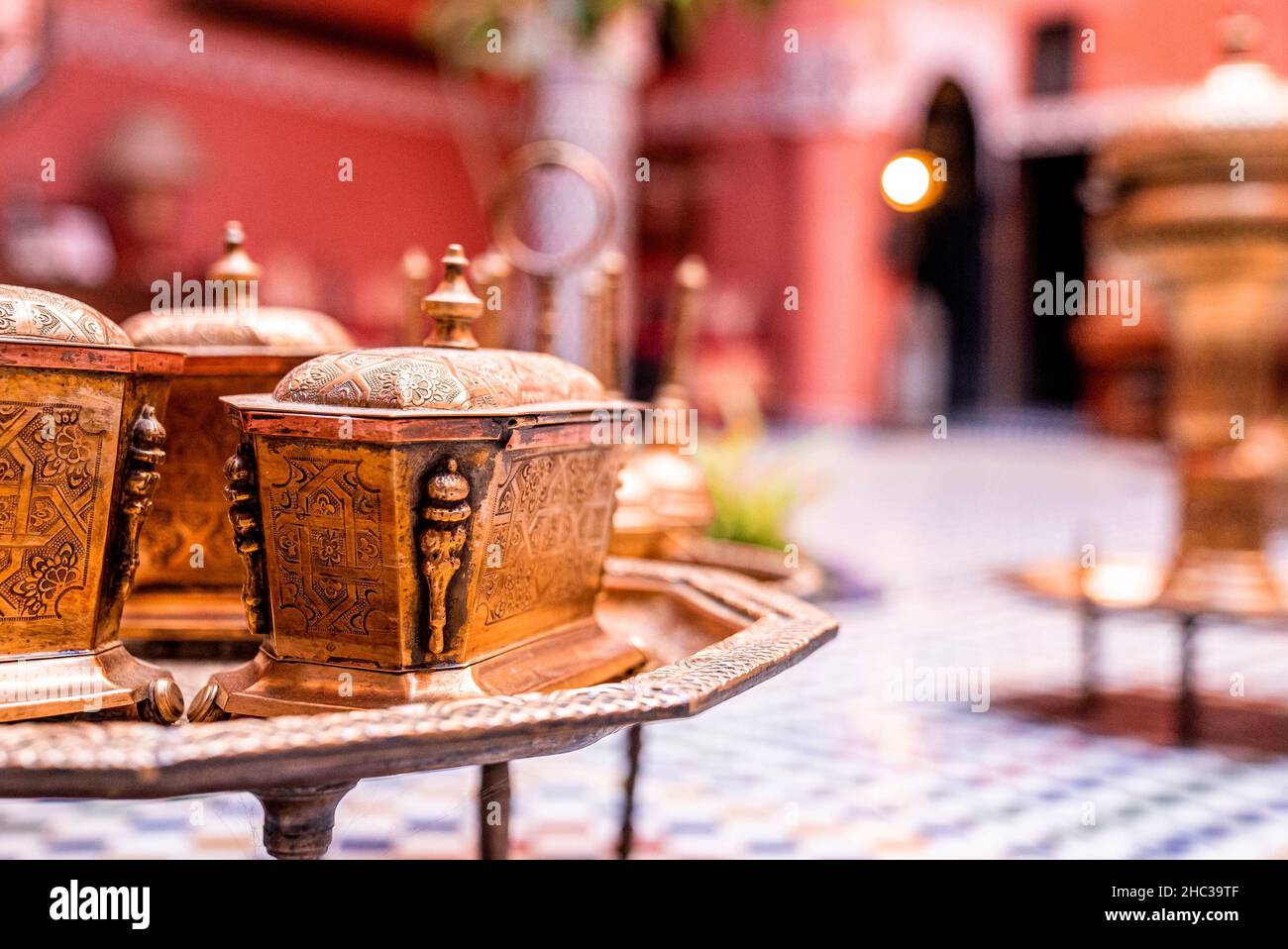 Ancient ornate brass pot with engraving on table Stock Photo - Alamy