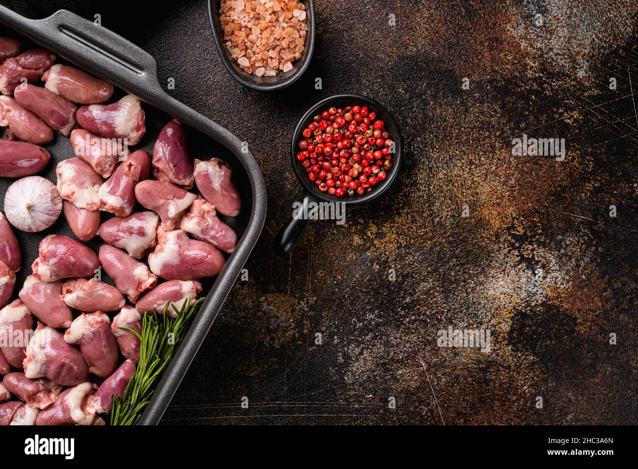 Raw bird hearts meat set, on old dark rustic table background, top view ...