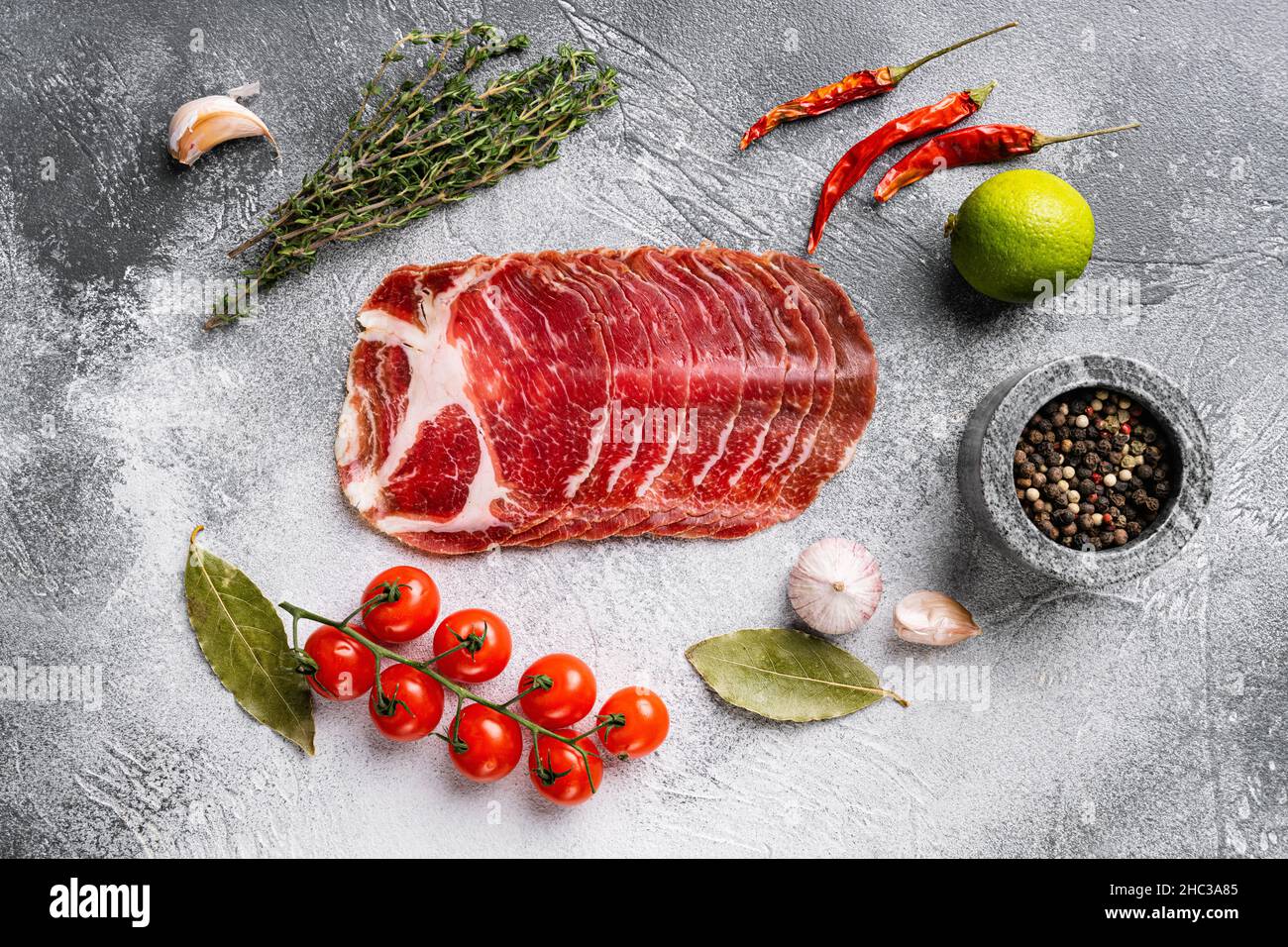 Cured meat, pork neck, coppa set, on gray stone table background, top ...