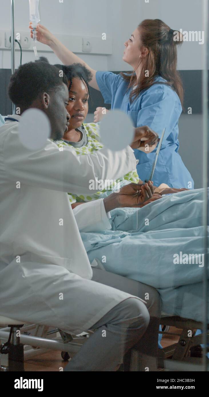 Man working as medic and explaining x ray scan results to patient with ...