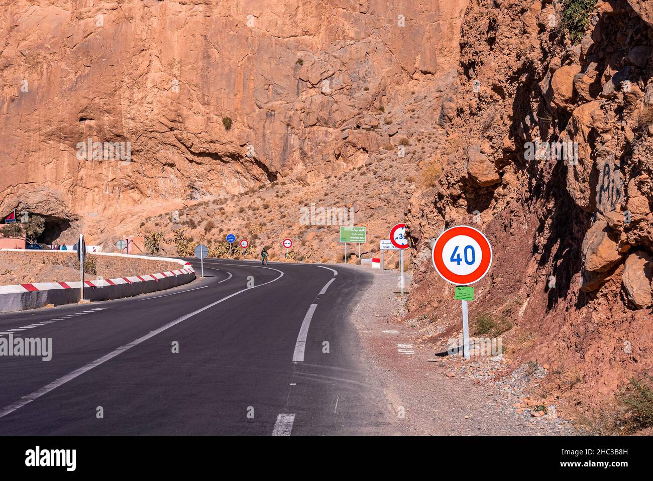 Asphalt road with markings and speed limit signs through mountain Stock ...