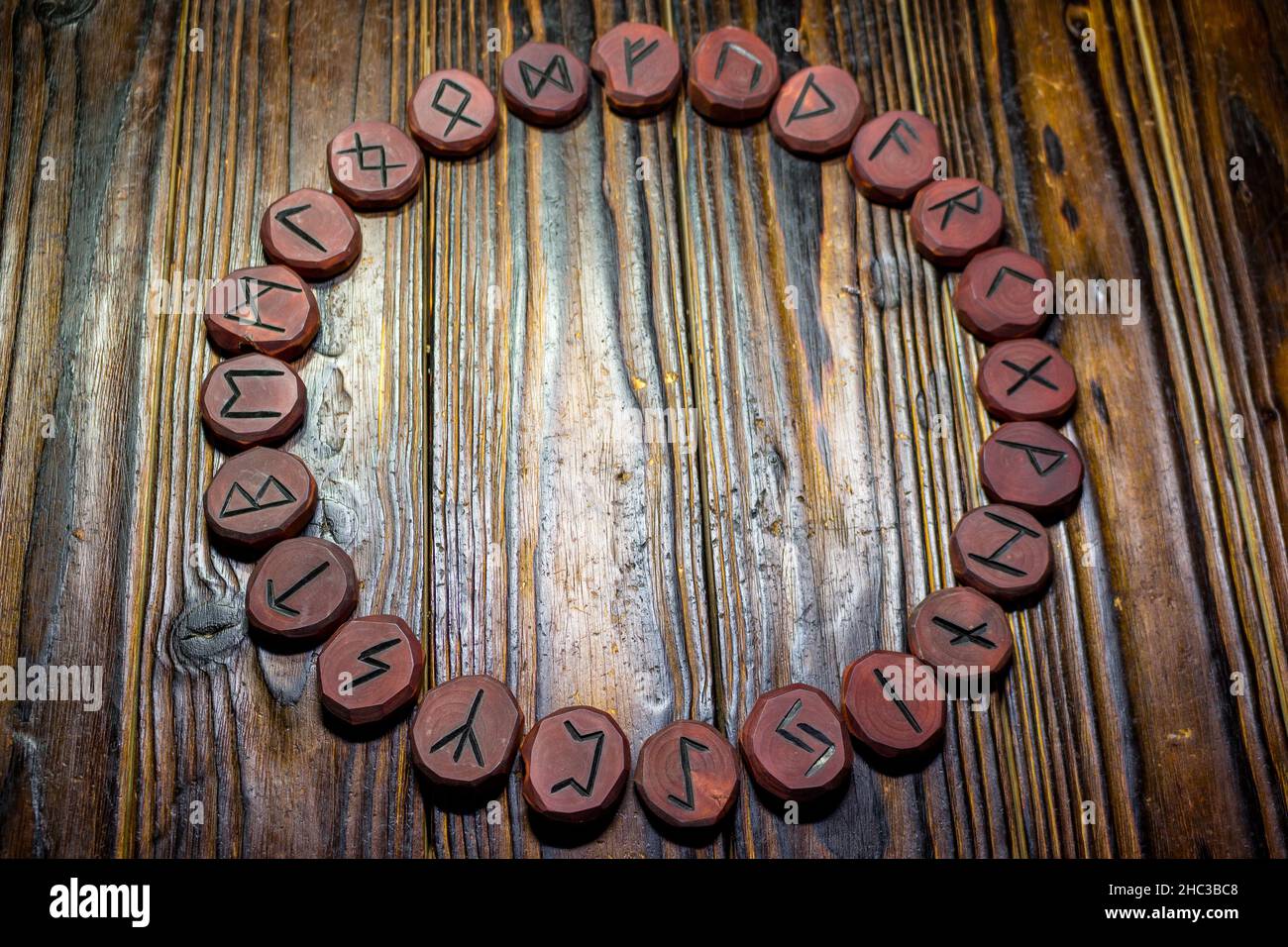 Rune circle on a wooden table. Red runes carved from wood, Elder ...