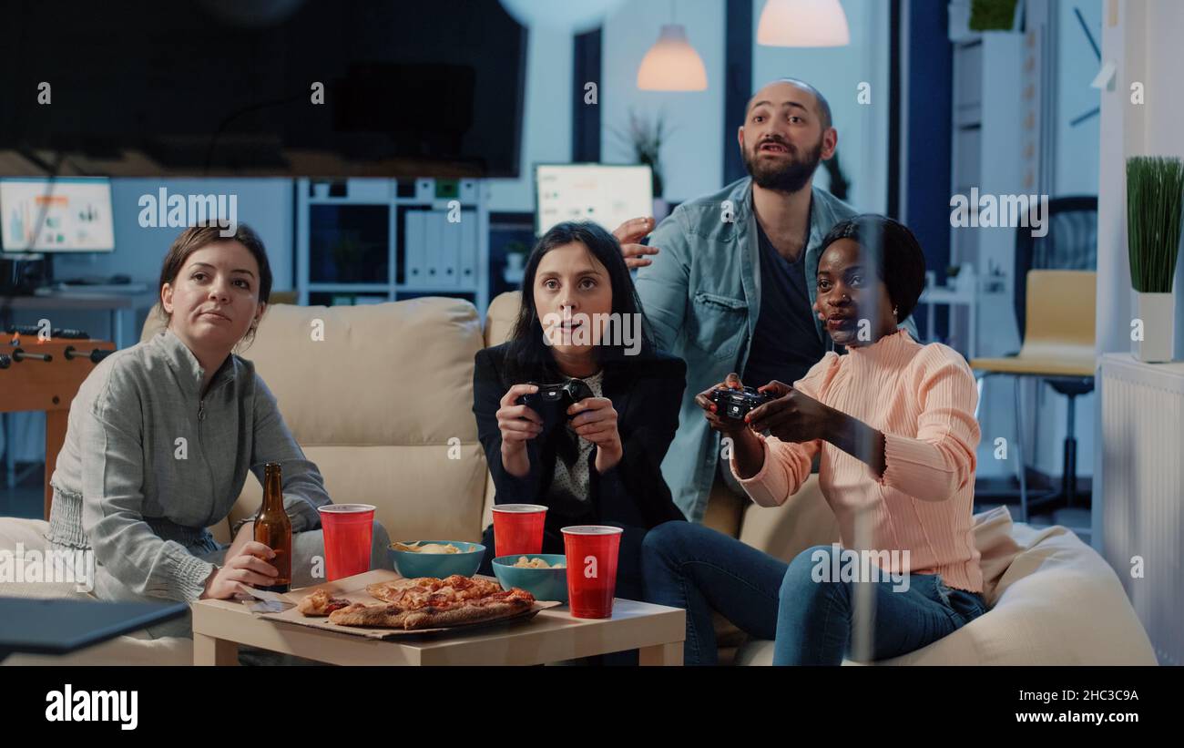 Frustrated colleagues playing video games and losing, enjoying free ...