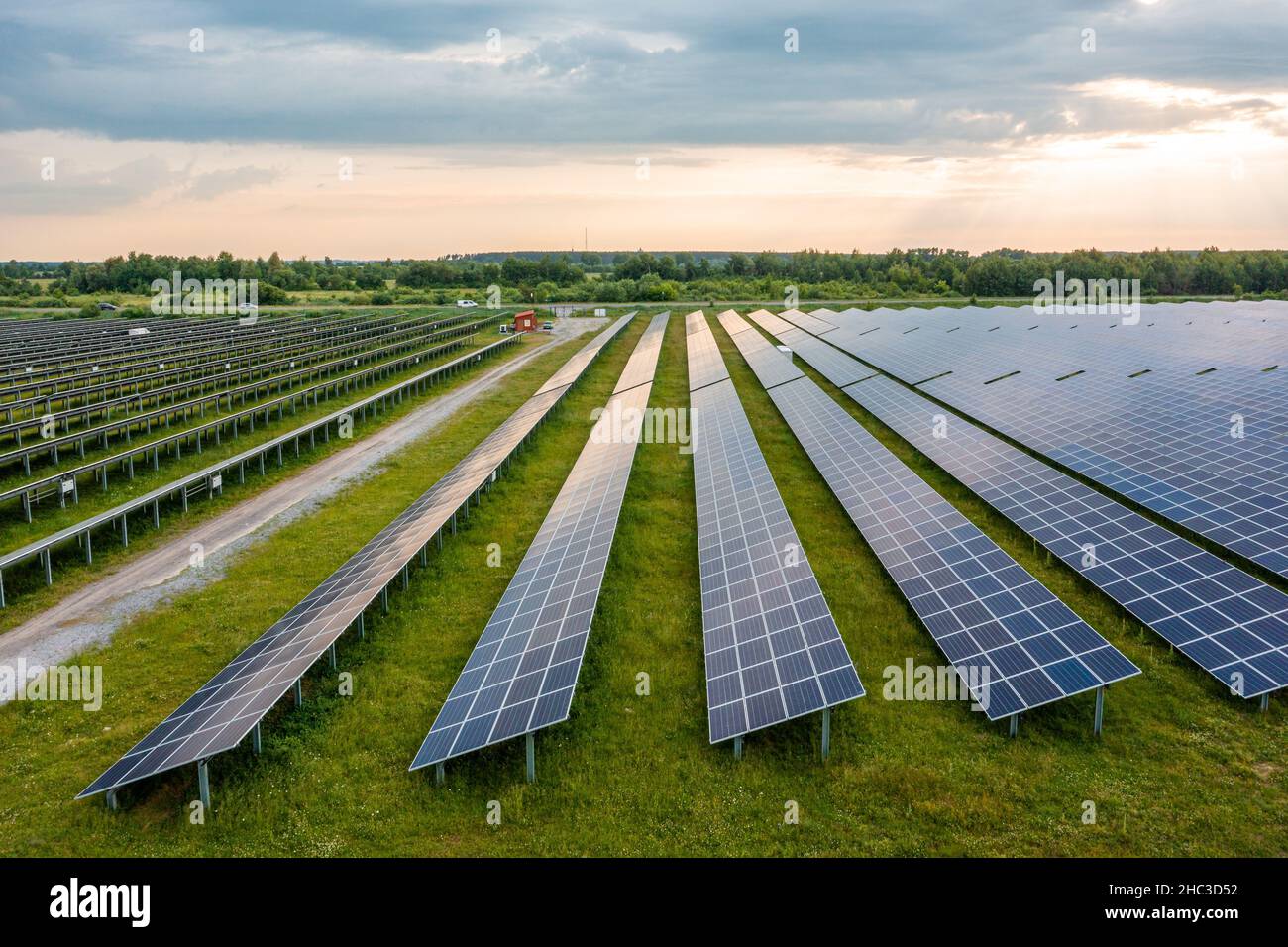 Huge solar power plant to use solar energy in a picturesque green field ...
