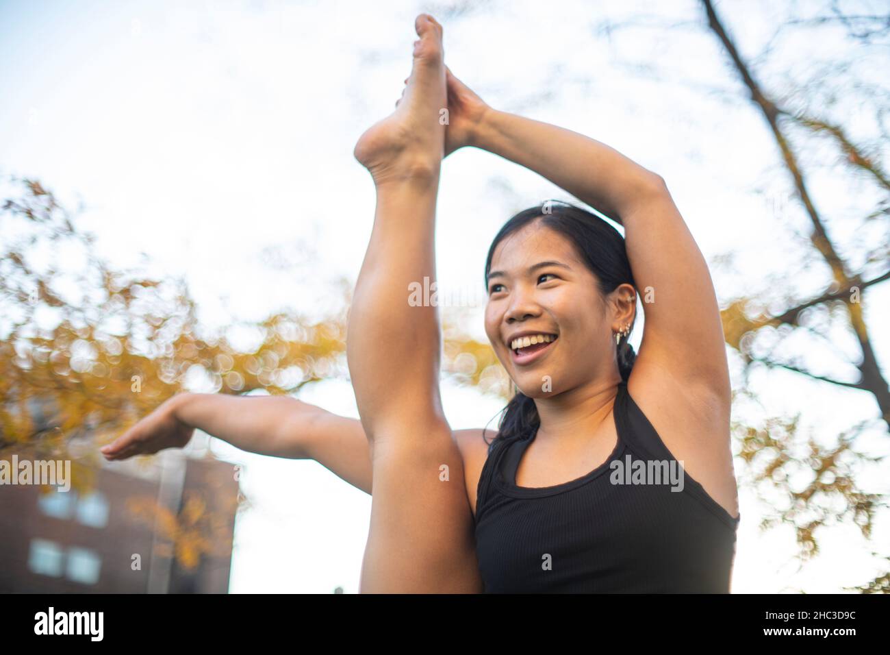 Portrait of smiling female gymnast outdoors Stock Photo - Alamy