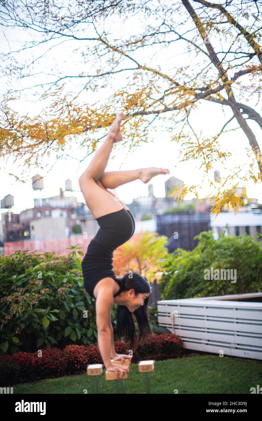 Female gymnast performing handstand outdoors Stock Photo - Alamy