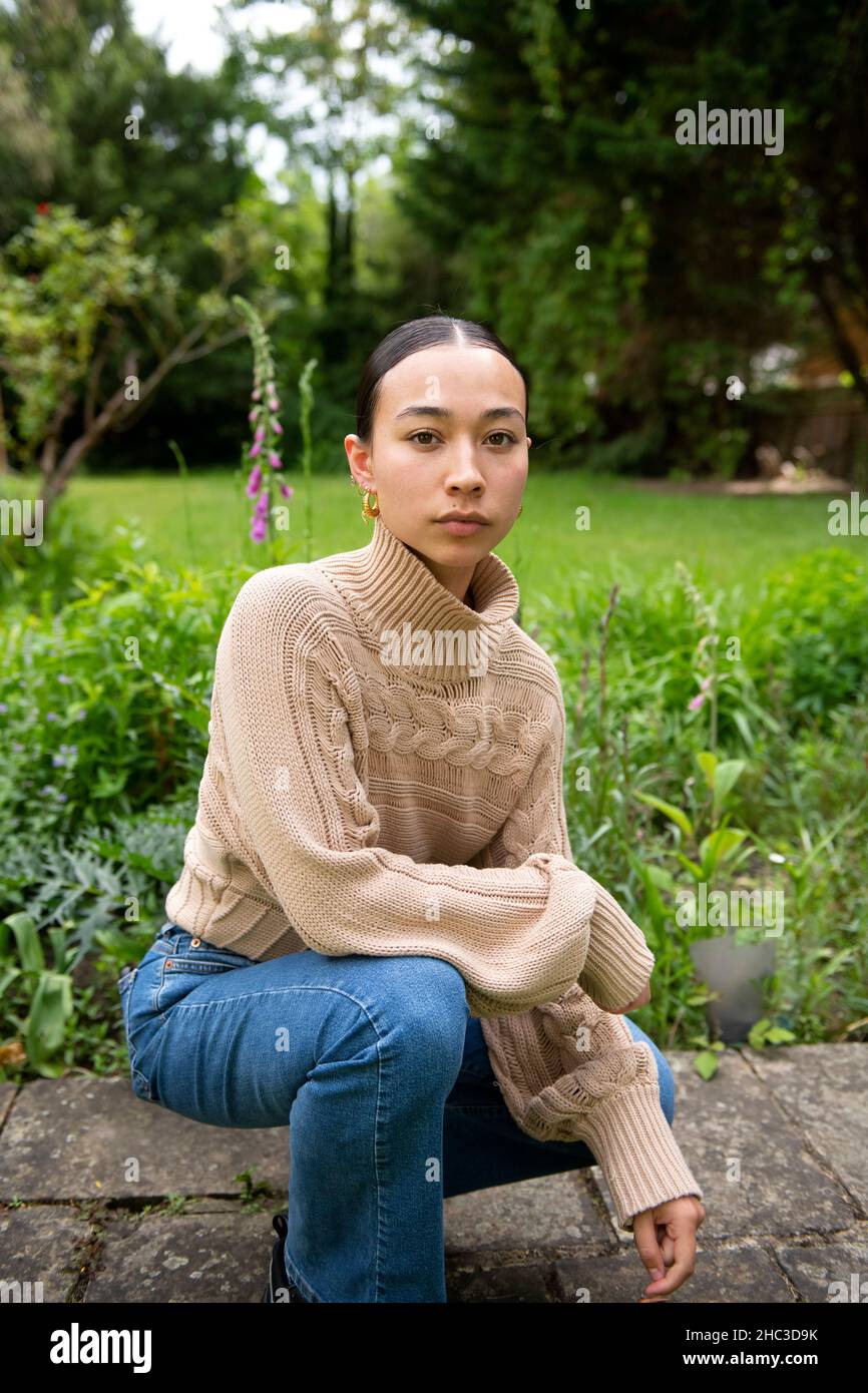 Portrait young woman crouching on hi-res stock photography and images ...