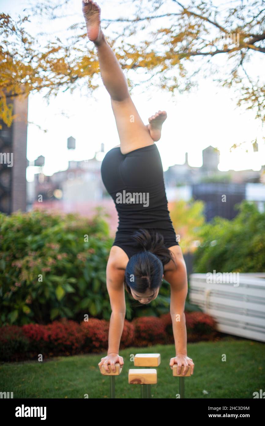 Female gymnast performing handstand outdoors Stock Photo - Alamy