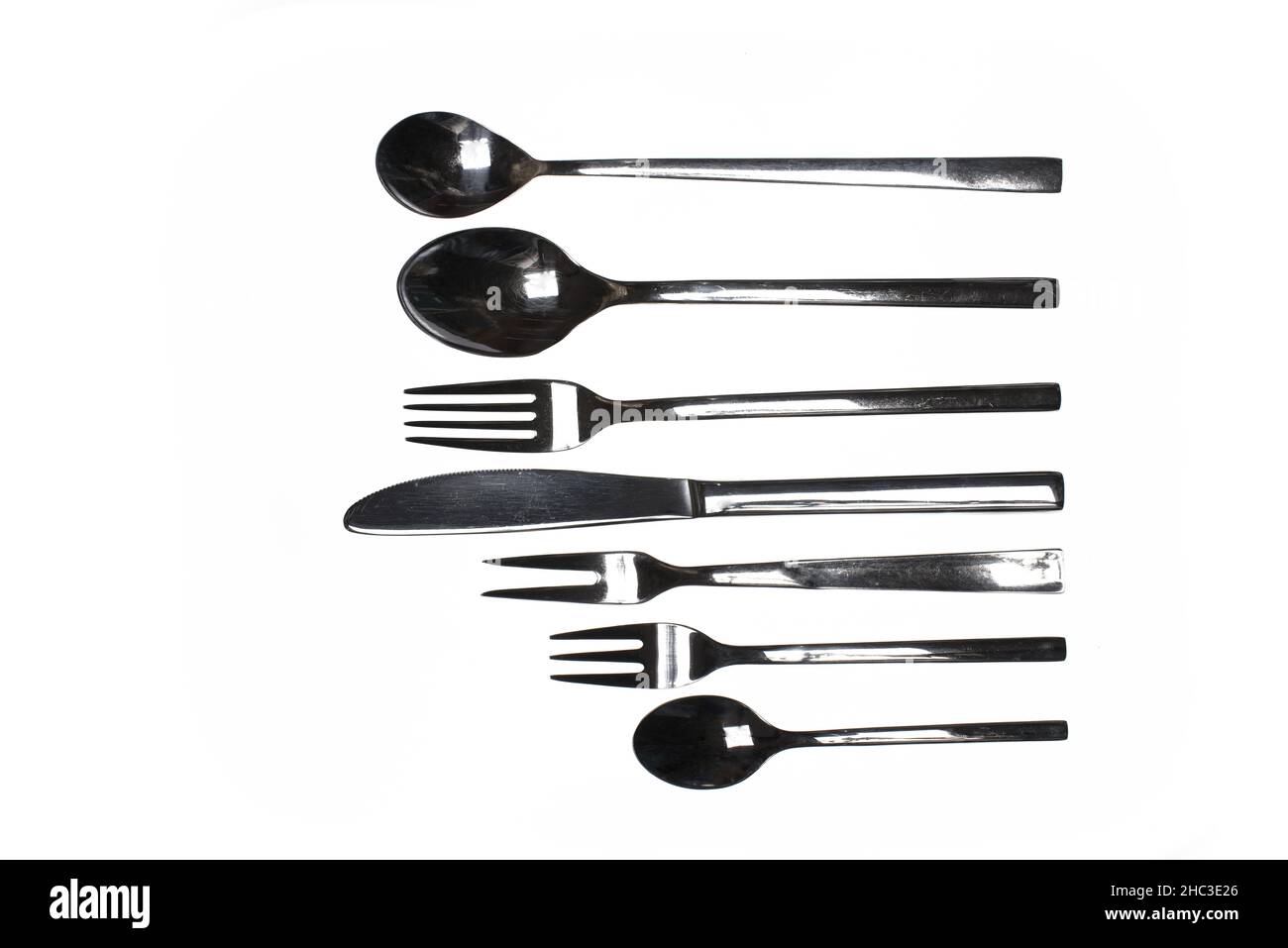 a complete cutlery set with knives forks and spoons isolated on white ...