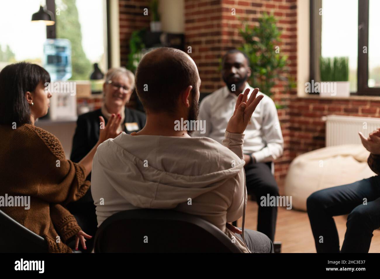Person sharing achievement with group of people at aa meeting, sitting ...
