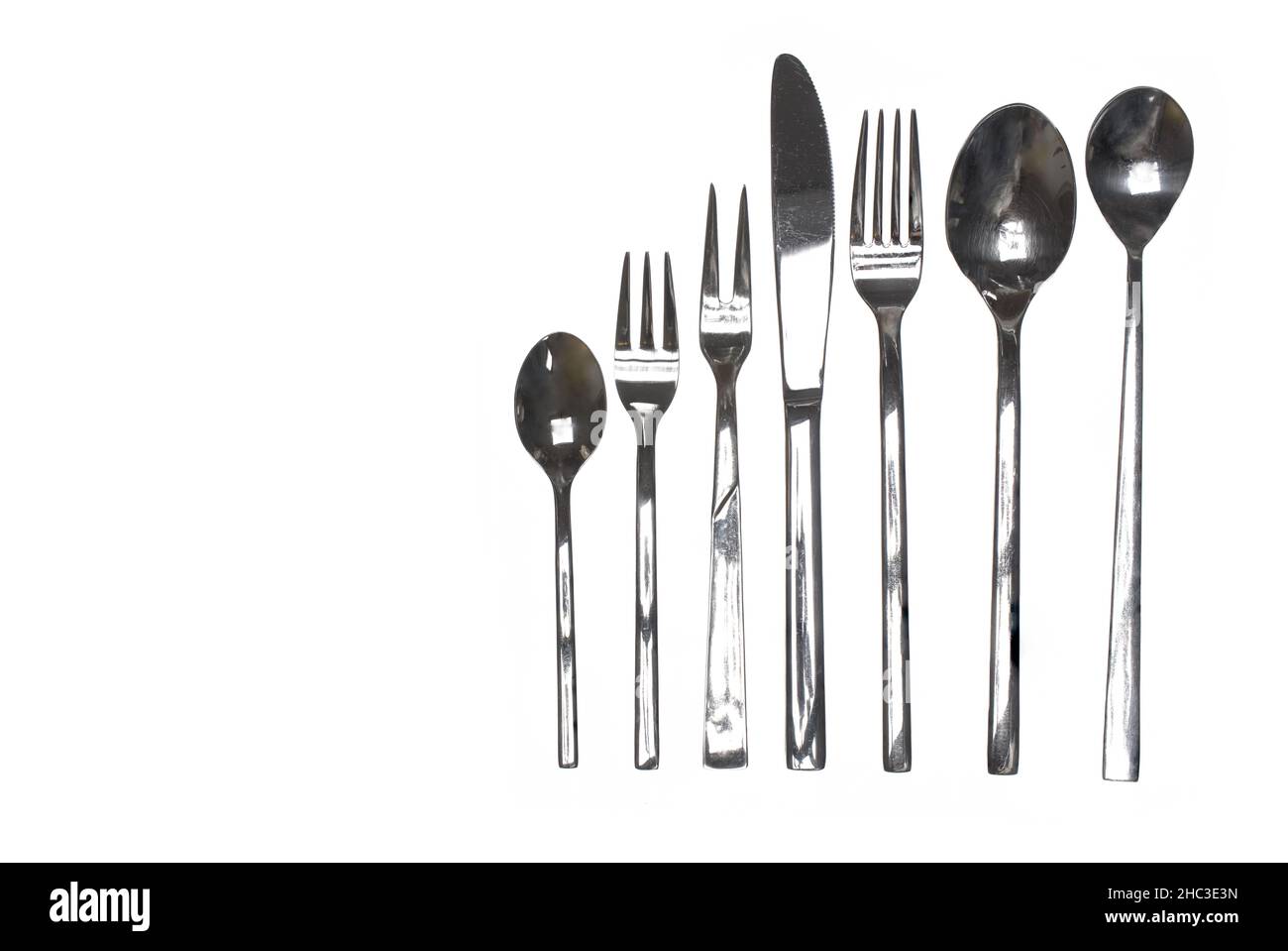 a complete cutlery set with knives forks and spoons isolated on white ...