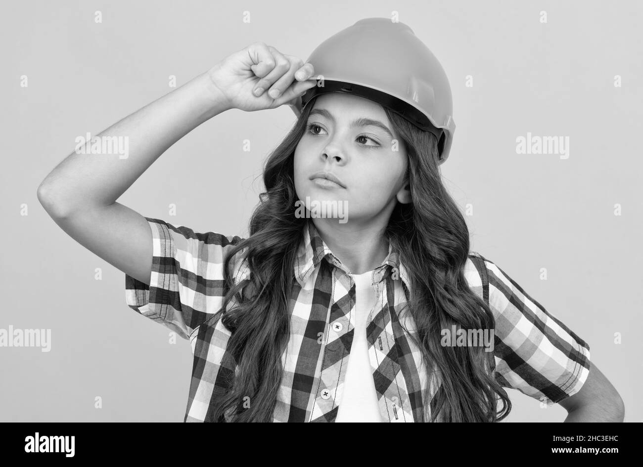 serious girl in protective hard hat. child wear helmet for building ...