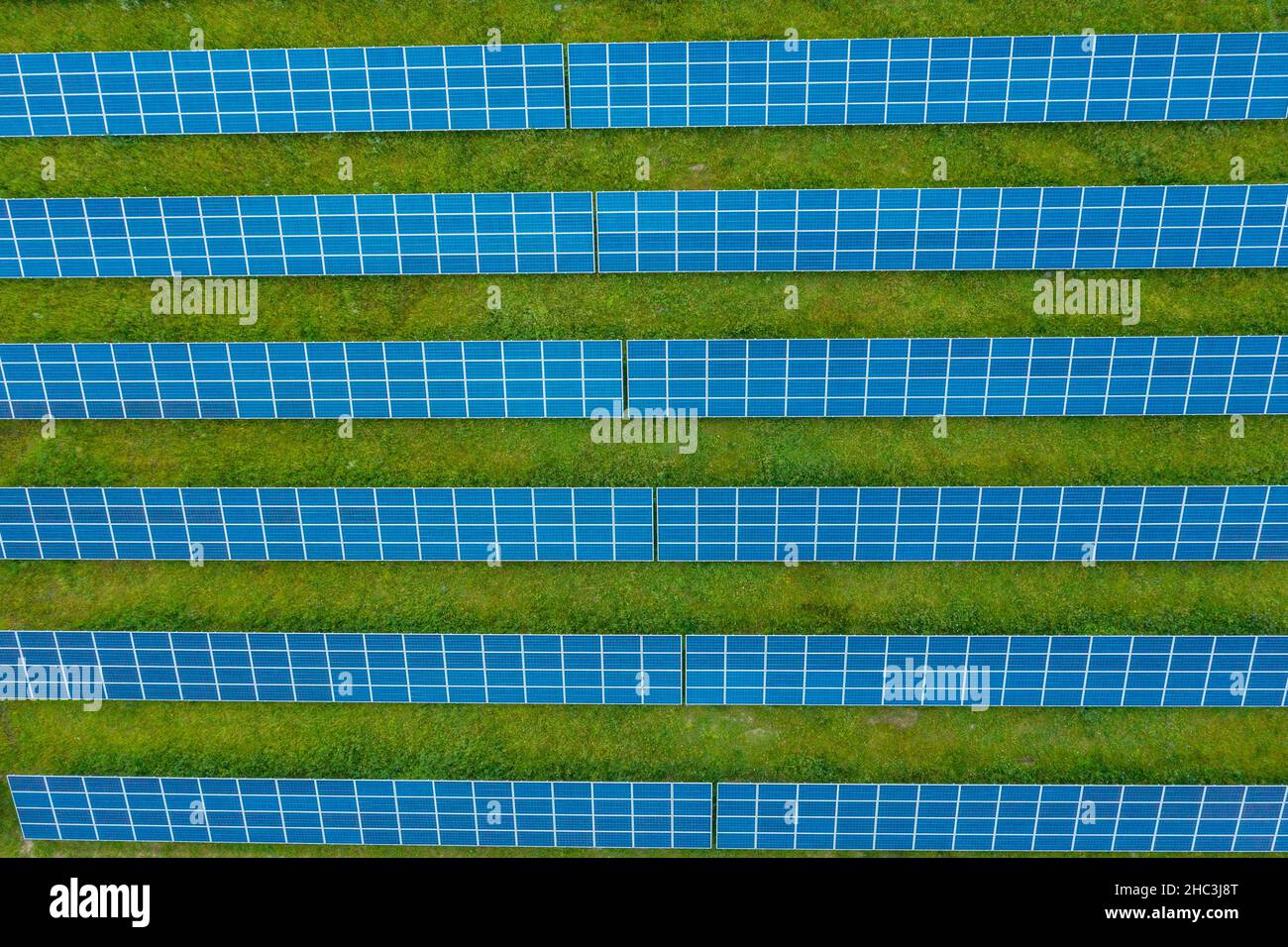 Huge solar power plant to use solar energy in a picturesque green field ...