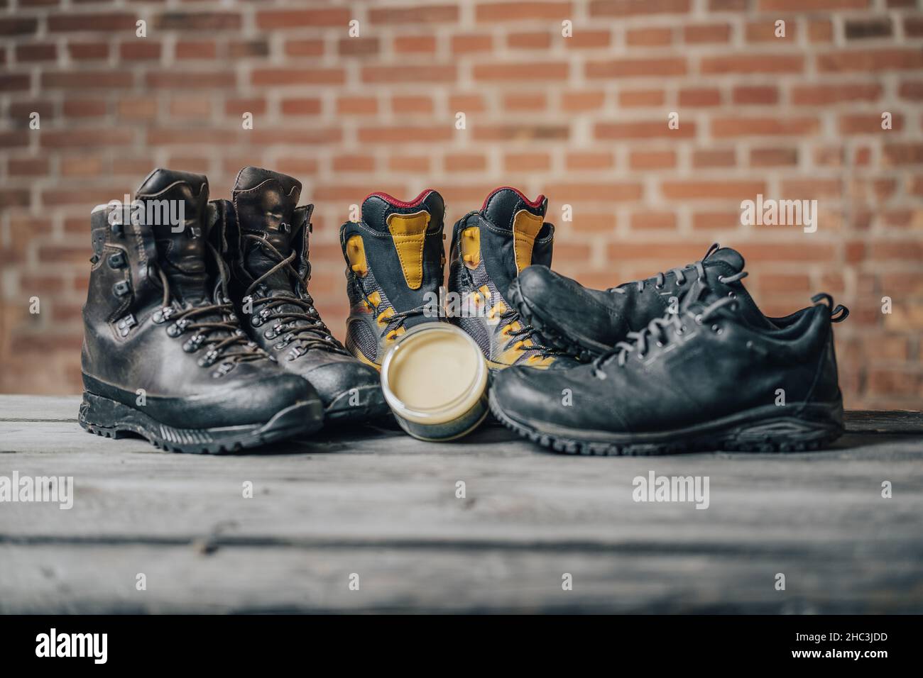 Leather outdoor shoes or boots with maintenance Set on wood background ...