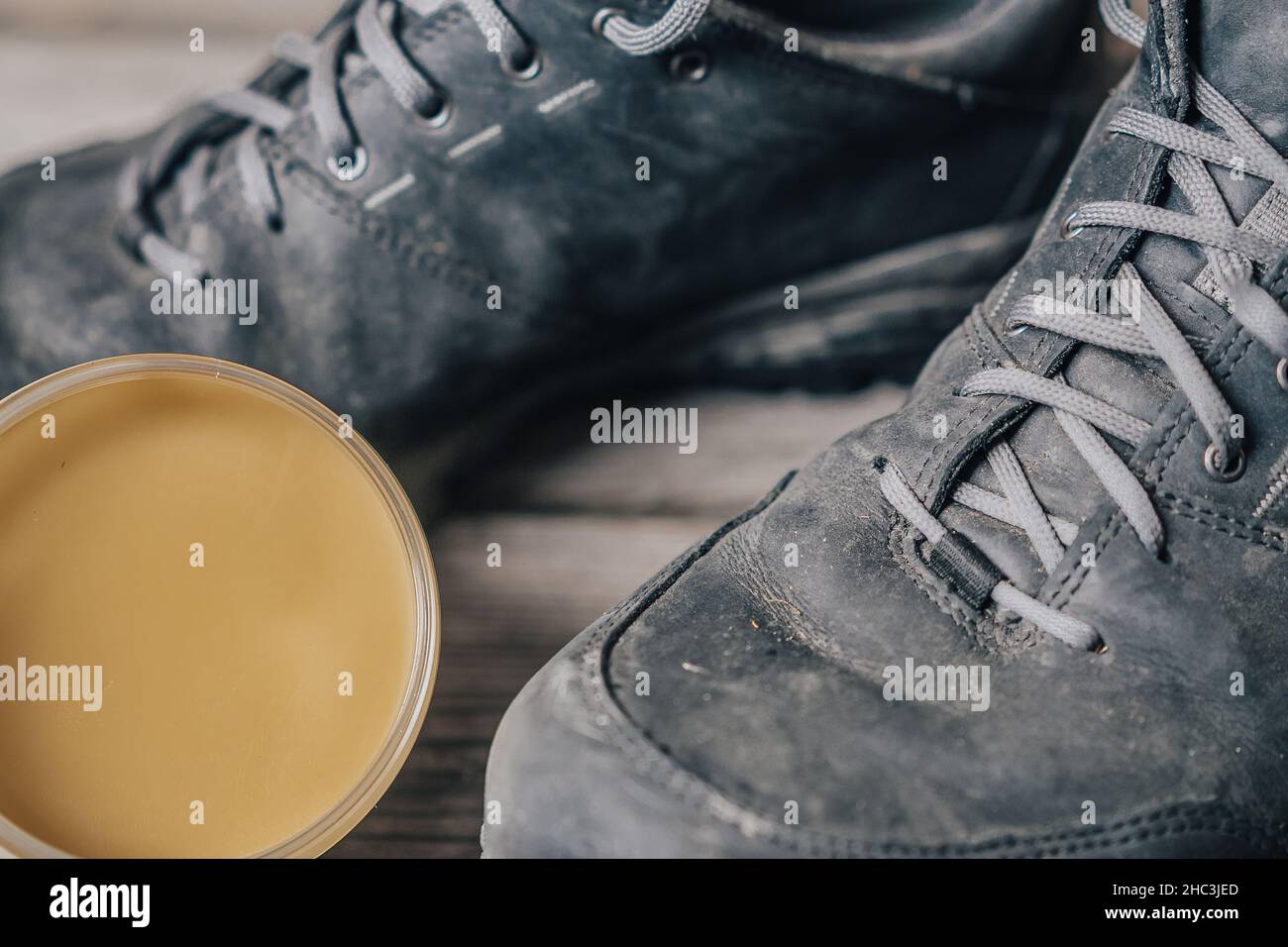 Leather outdoor shoes or boots with maintenance Set on wood background ...