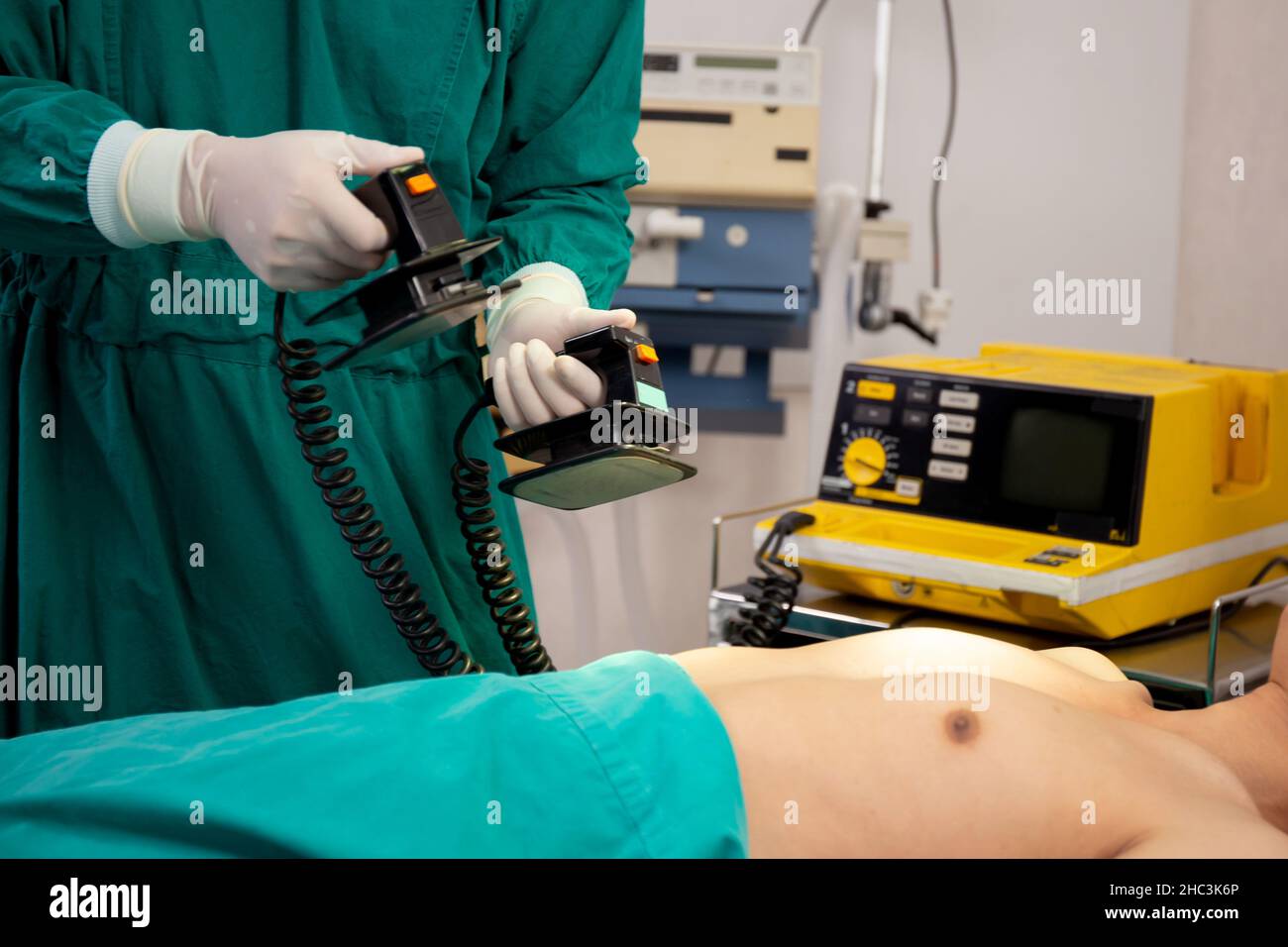 Doctor and surgeon CPR machine pump heart of patient emergency on chest ...