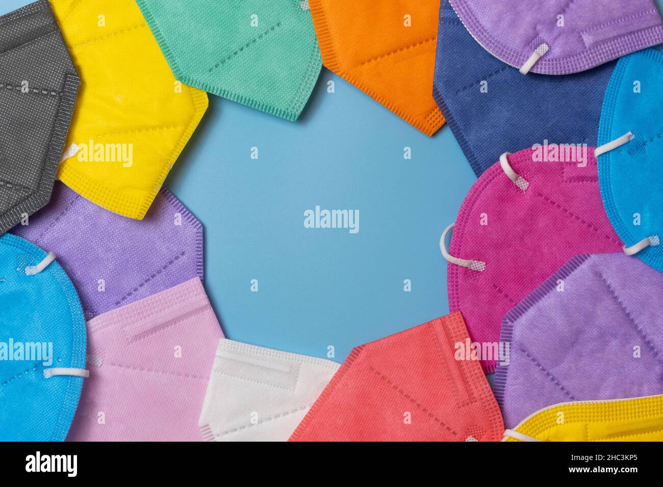 Top view of a table with colorful face masks piled and space to copy ...