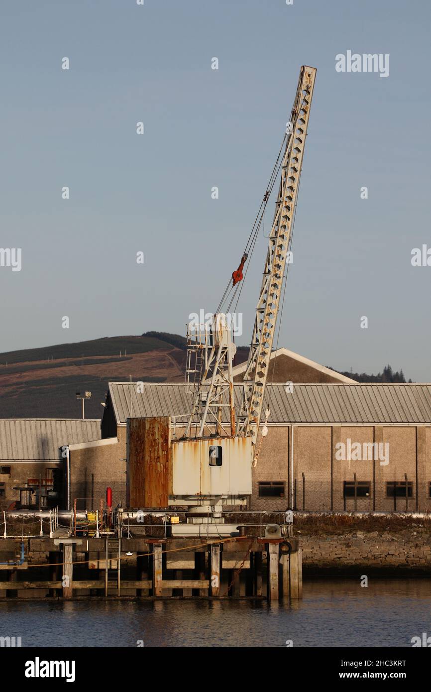 A rusting harbourside crane on the Firth of Clyde, at Great Harbour in ...