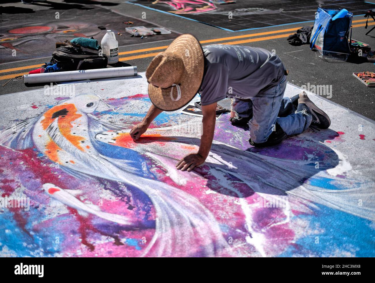 Street chalk artist drawing a large, colorful picture Stock Photo - Alamy
