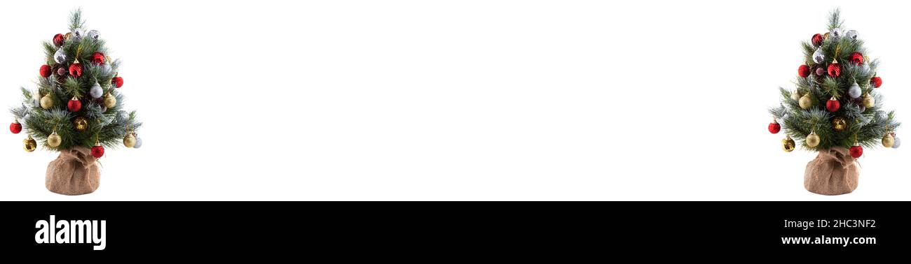 Christmas pine trees in pots wrapped in cloth. Decorated with colorful ...