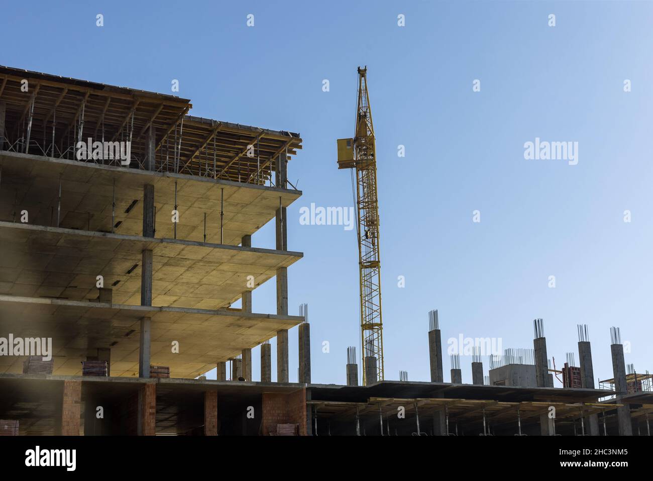 Steel frames of a building under construction with tower crane on top ...