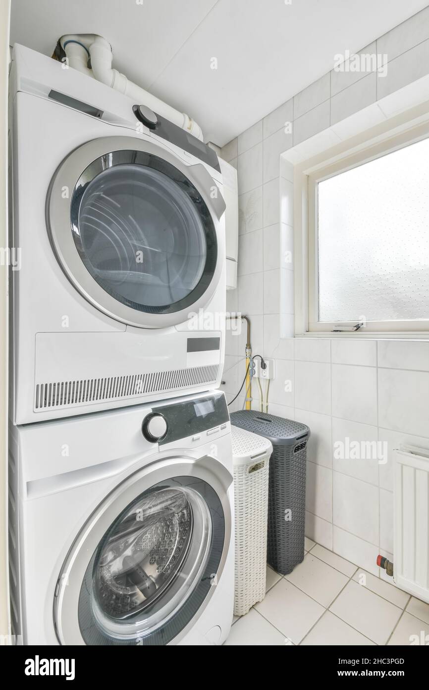 Laundry area in the corner of the room with washer and dryer Stock ...
