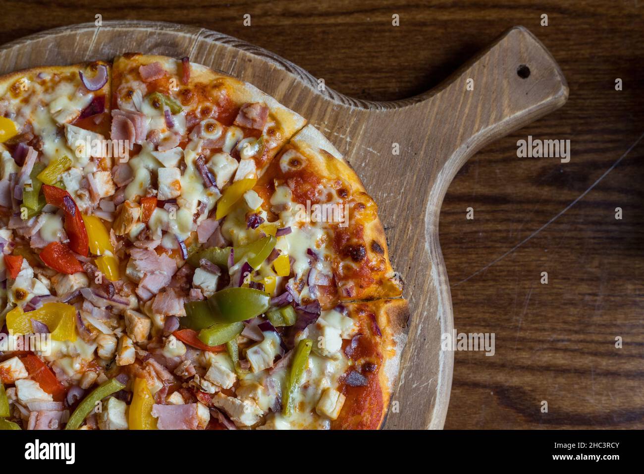 A top view of a delicious Italian pizza with colorful peppers and bacon ...