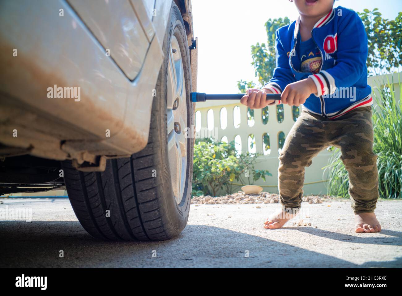 Little boy repairing car and changing wheel fixing a car Stock Photo ...
