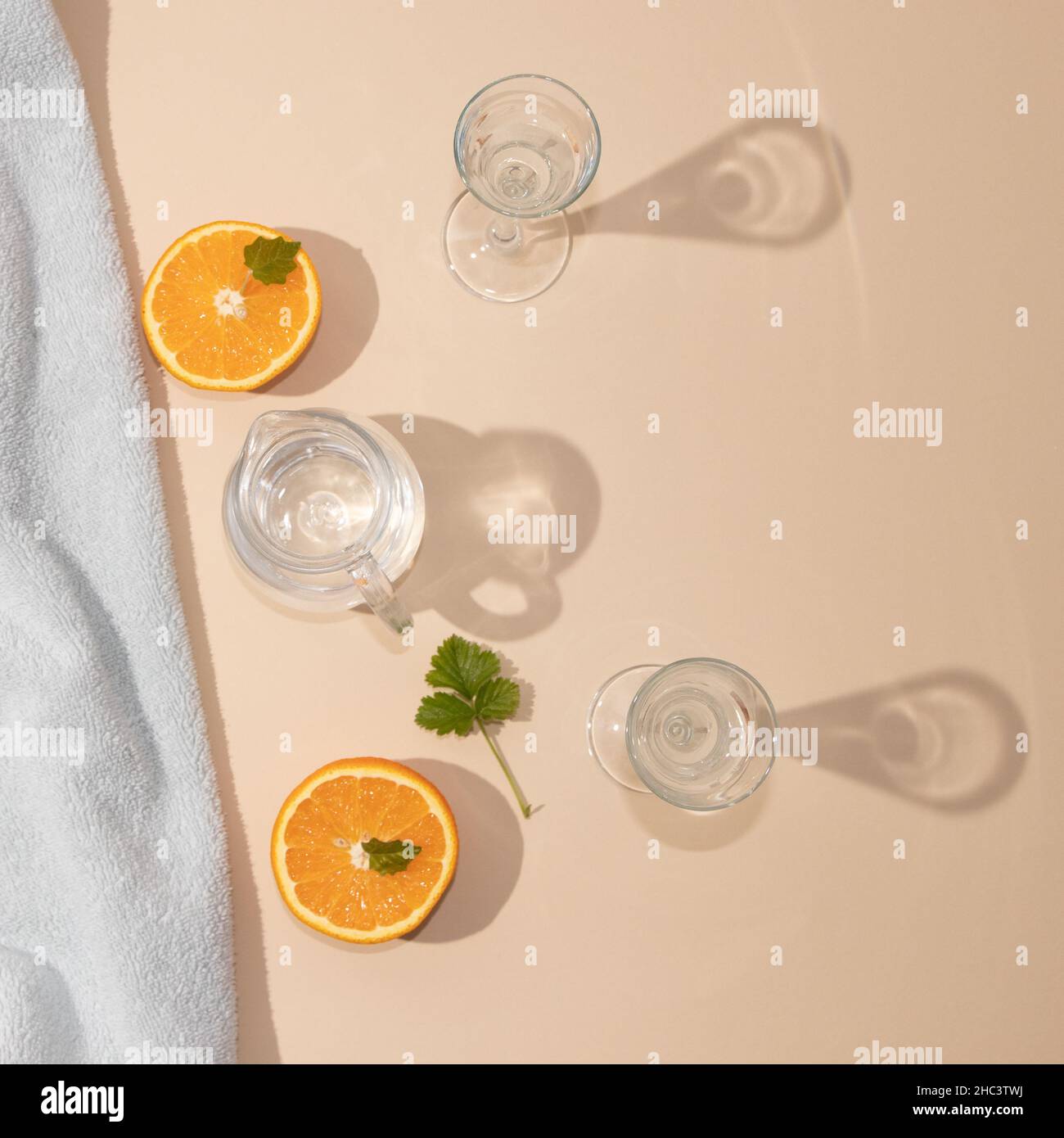 Summer scene with bright blue beach towel and glass and orange fruit ...