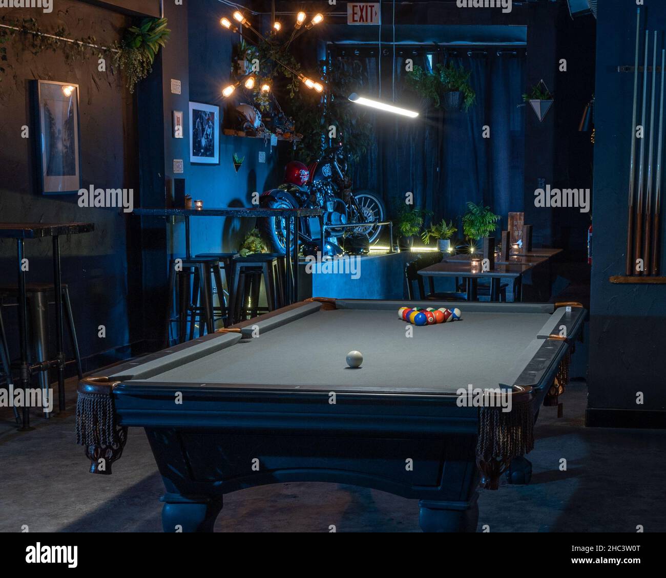 Pool table with organized balls in an illuminated bar Stock Photo - Alamy