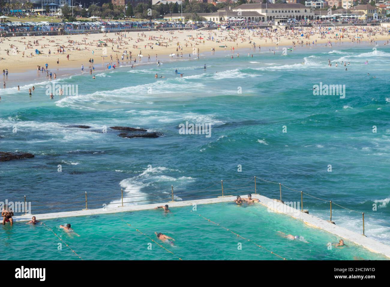 Aerial view of people swimming in a pool and a nearby sunny beach Stock ...
