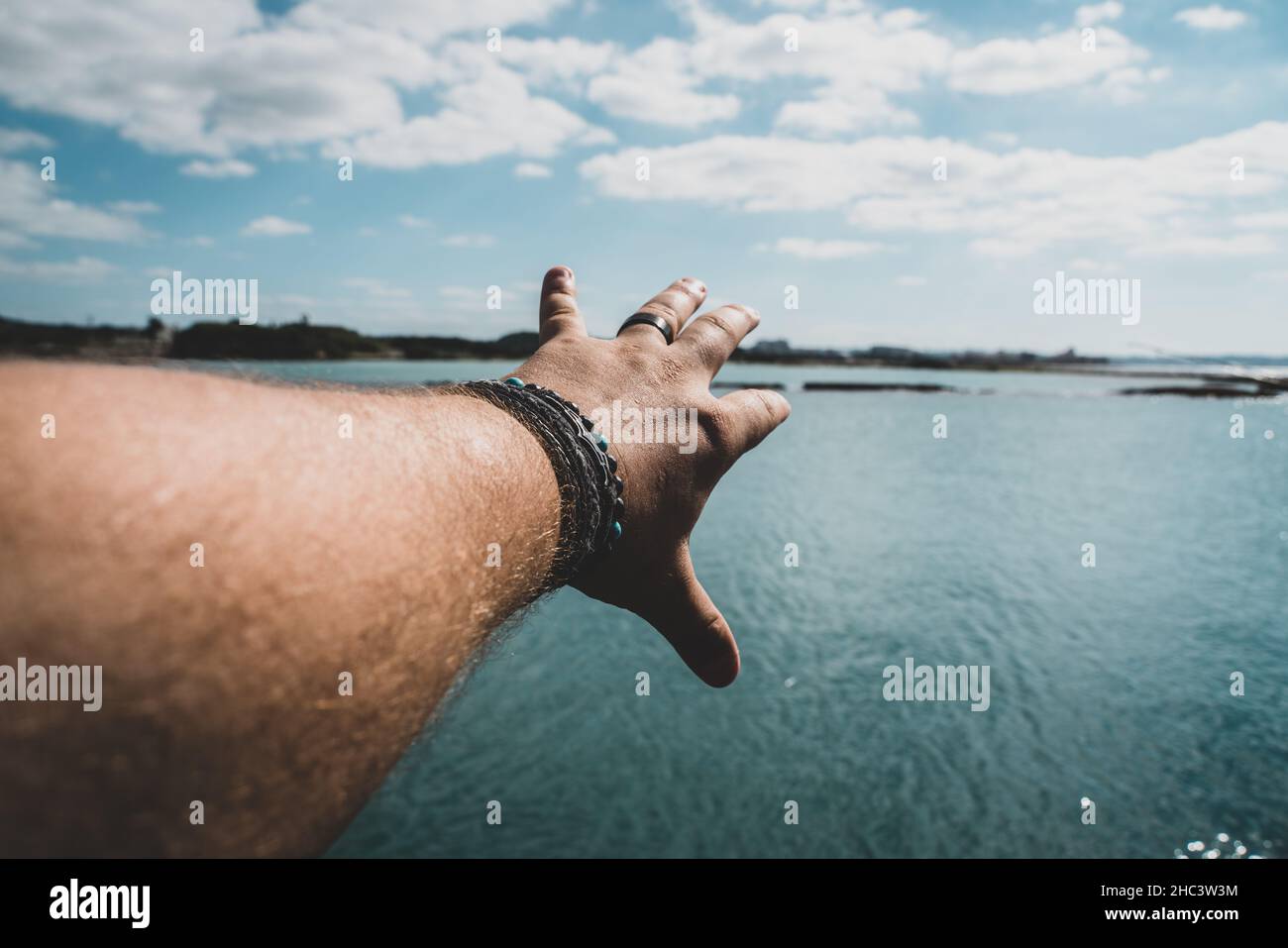 Hand of a male heading to the sea view Stock Photo - Alamy