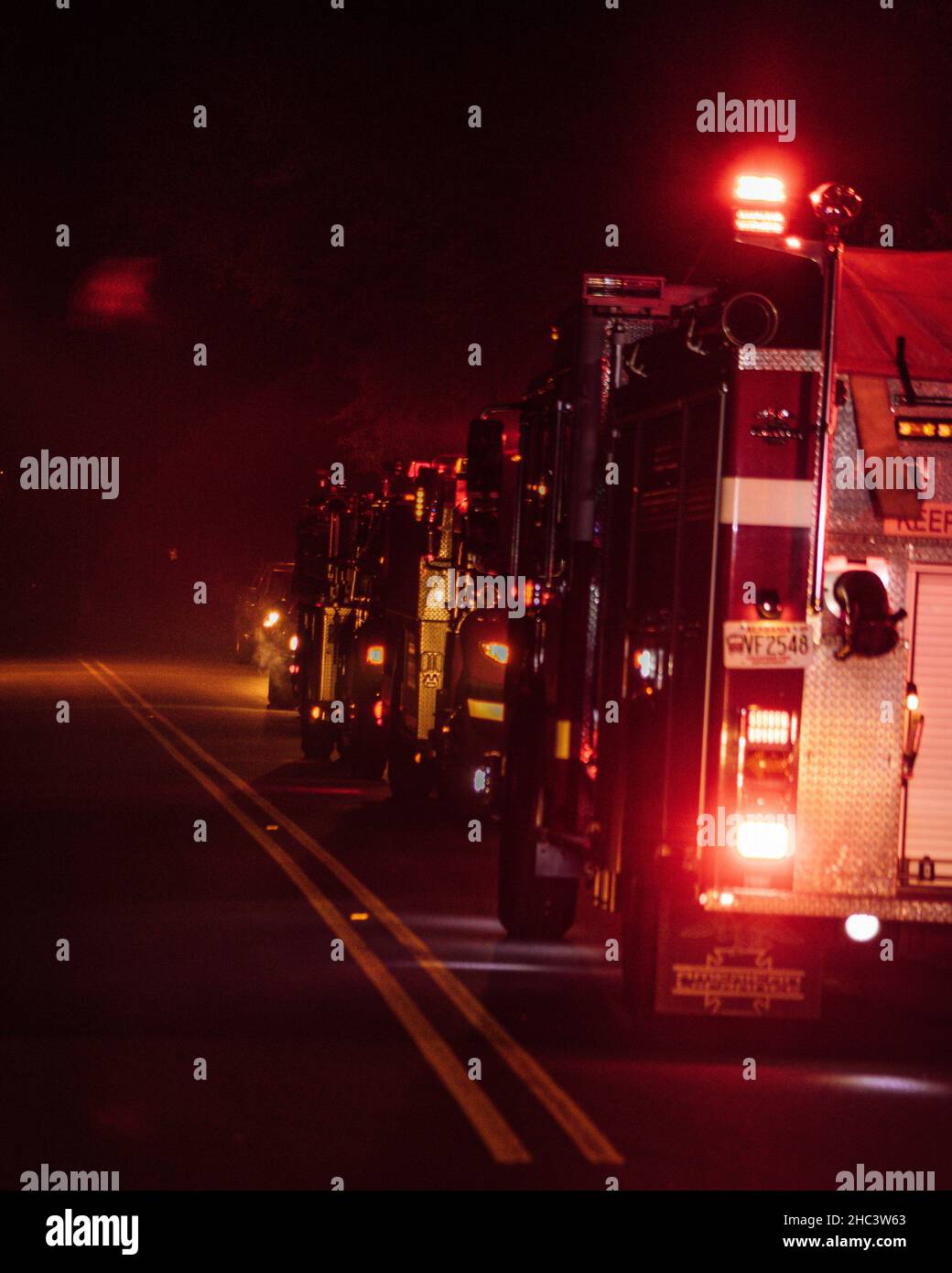Vertical shot of fire engines at night Stock Photo - Alamy